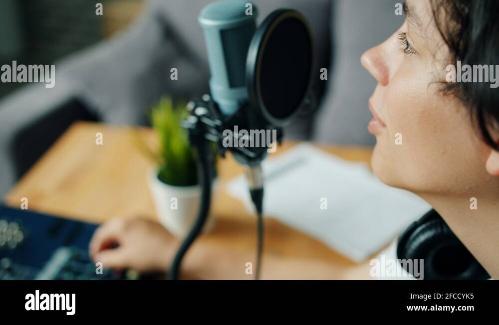 Close-up of handsome teenage boy talking in recording studio using ...