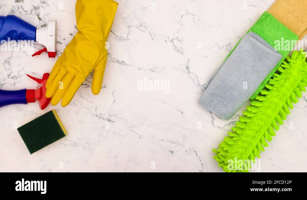 Stop motion animation of hand with yellow gloves clean the table with ...
