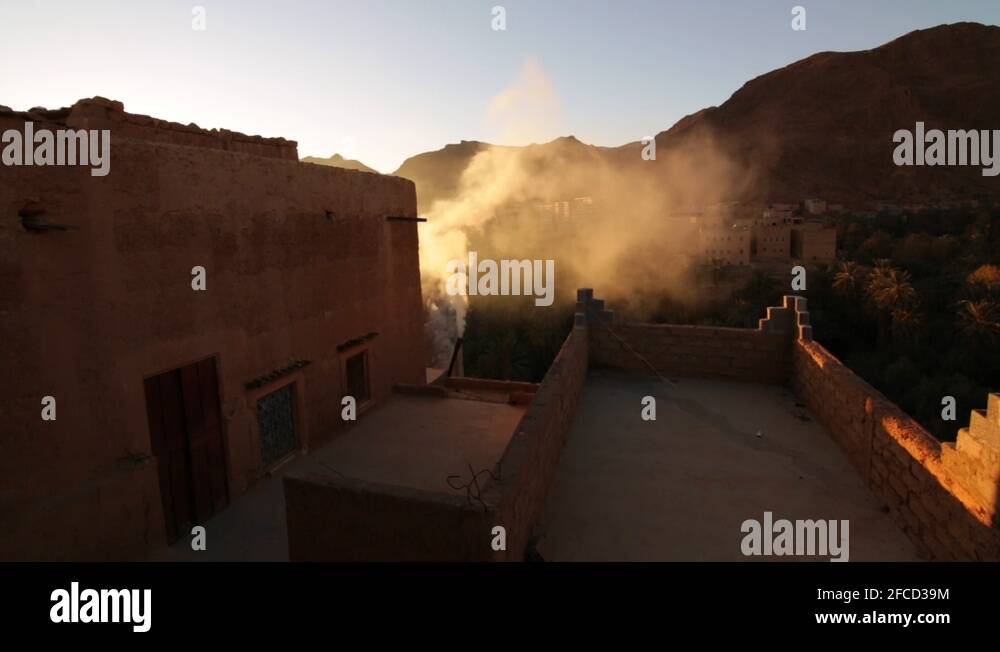 Todra gorge Moroccan style kasbah housing in desert with rooftop smoke ...
