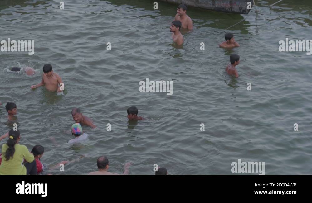People Bathing And Swimming In the Holy Ganges River At The Varanasi ...