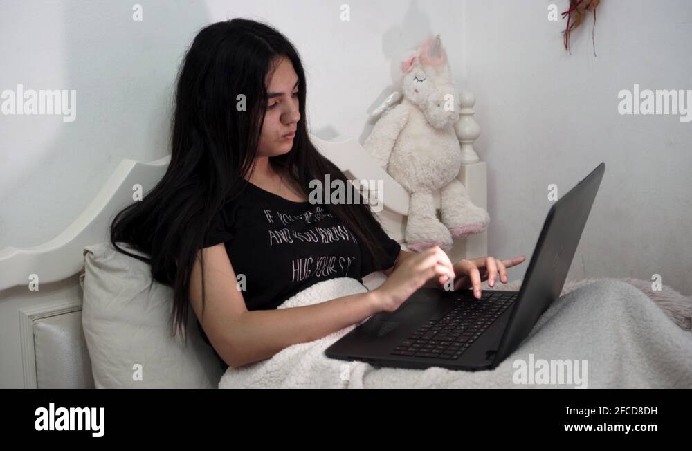 Young girl types on her computer Stock Video Footage - Alamy