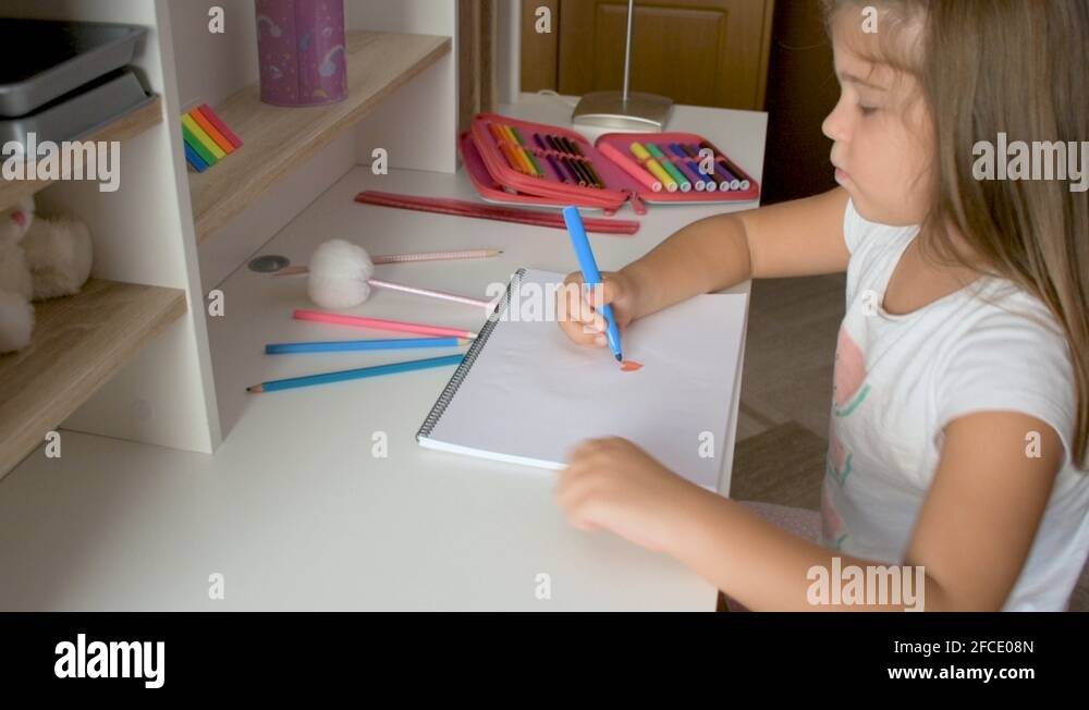 Little girl at her table drawing Stock Video Footage - Alamy