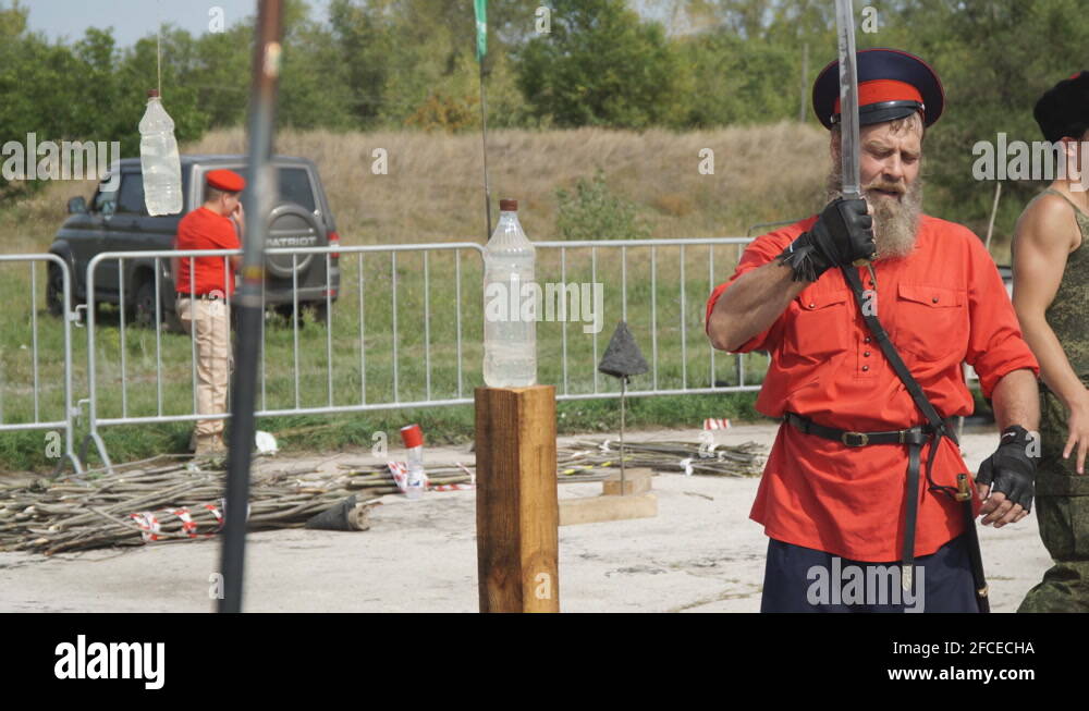 Cossack with a beard in a red shirt shows a cavalry saber Stock Video ...