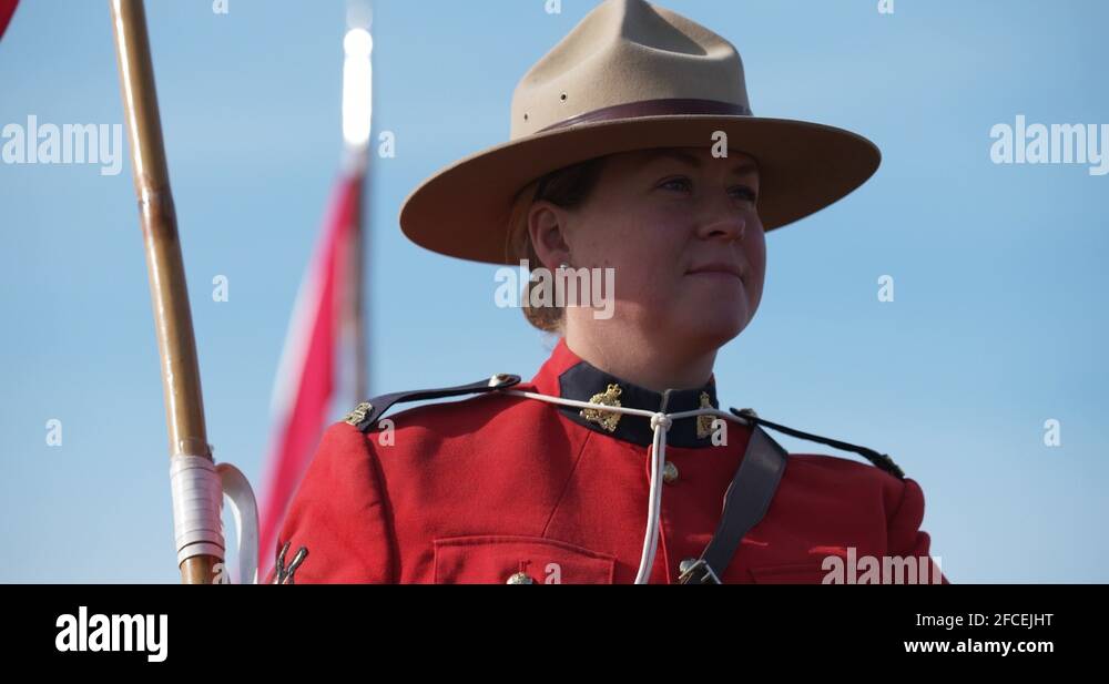 Medium closeup of female officer of Royal Canadian Mounted Police, slow ...