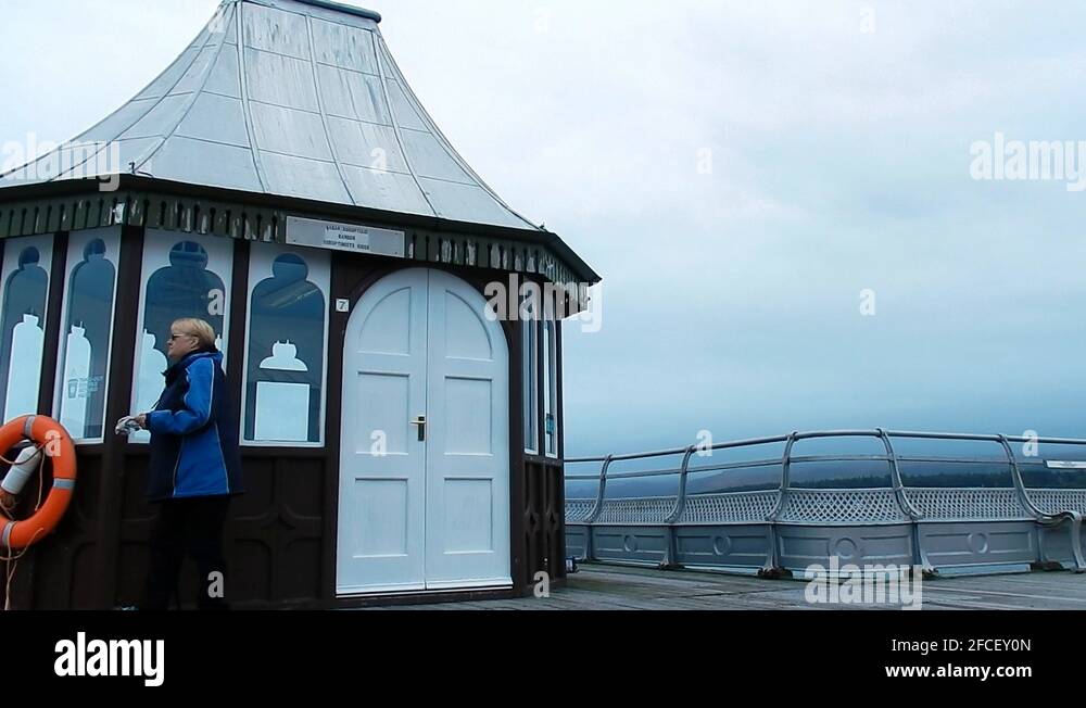 Tourists visiting British seaside Victorian Promenade in North Wales ...