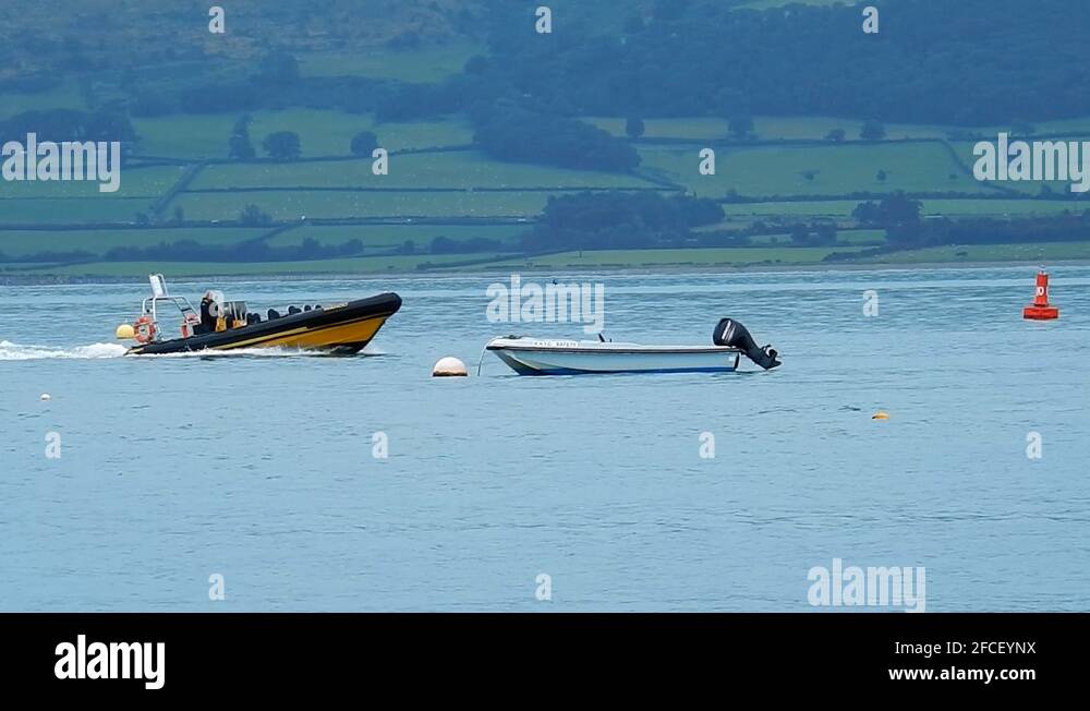 Tourism speed boat travelling across North Wales Menai strait misty ...