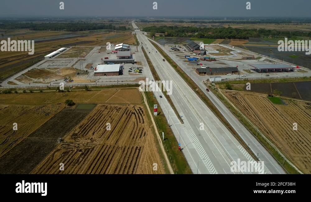 Two way four lane toll road aerial view from drone flying backward ...