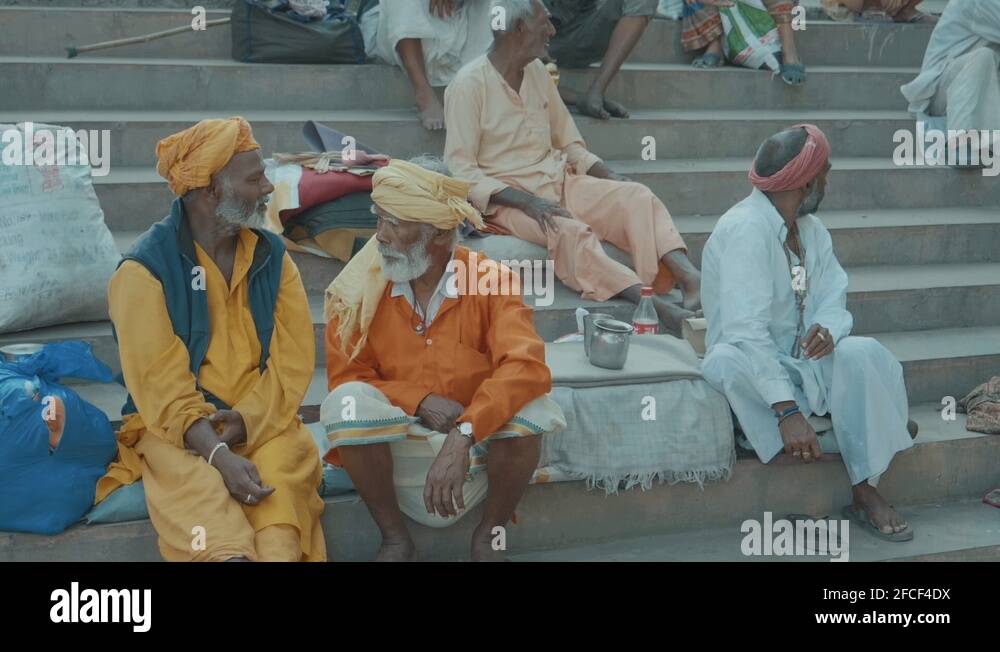 Group Of Indian Men Sitting On Stairs Together Talking In Traditional ...