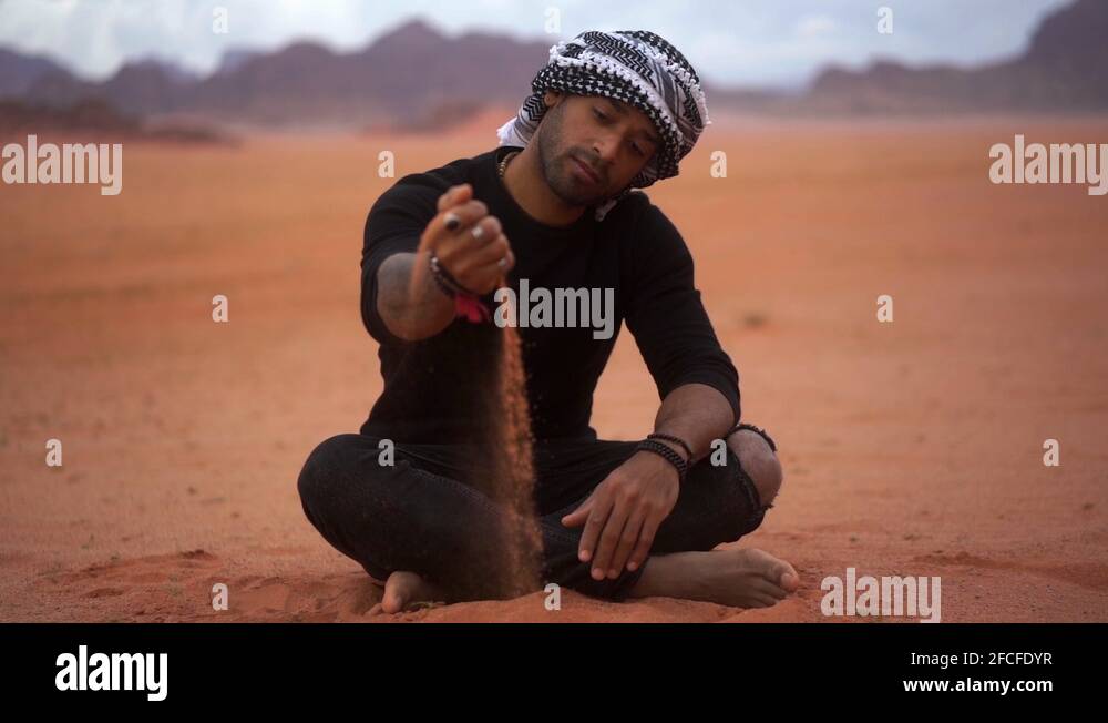 Arab man grabbing sand while escaping between his fingers Stock Video ...
