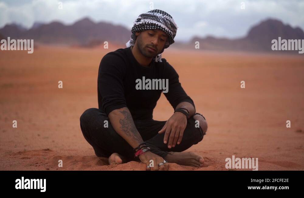 Arab man grabbing sand while escaping between his fingers Stock Video ...