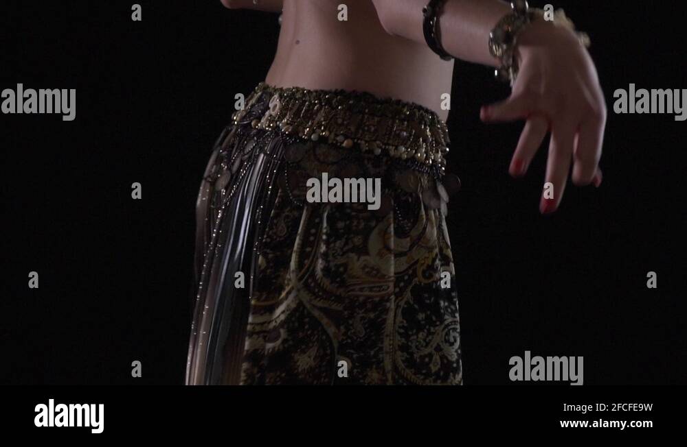 Close up of a blonde woman in traditional dress, dancing an eastern ...