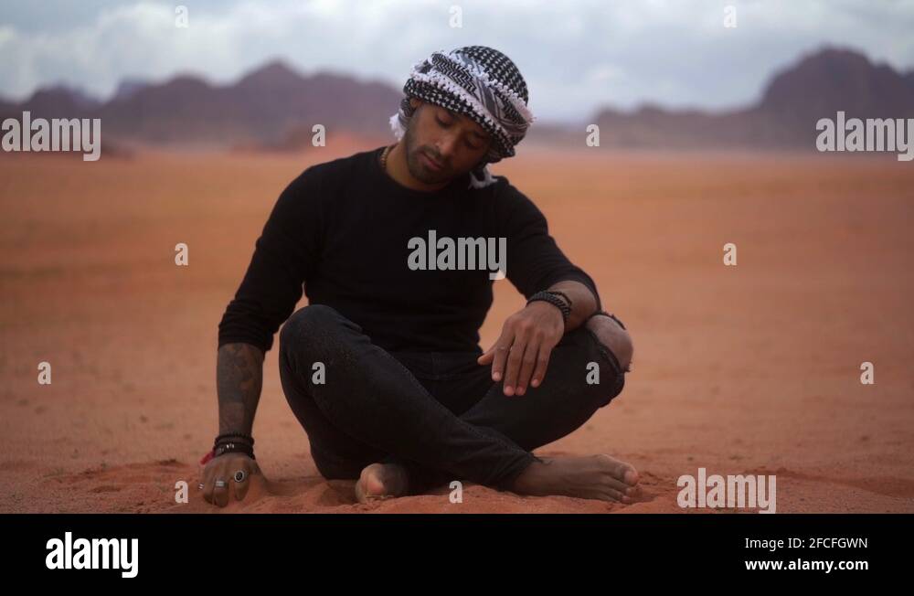 Arab man grabbing sand while escaping between his fingers Stock Video ...