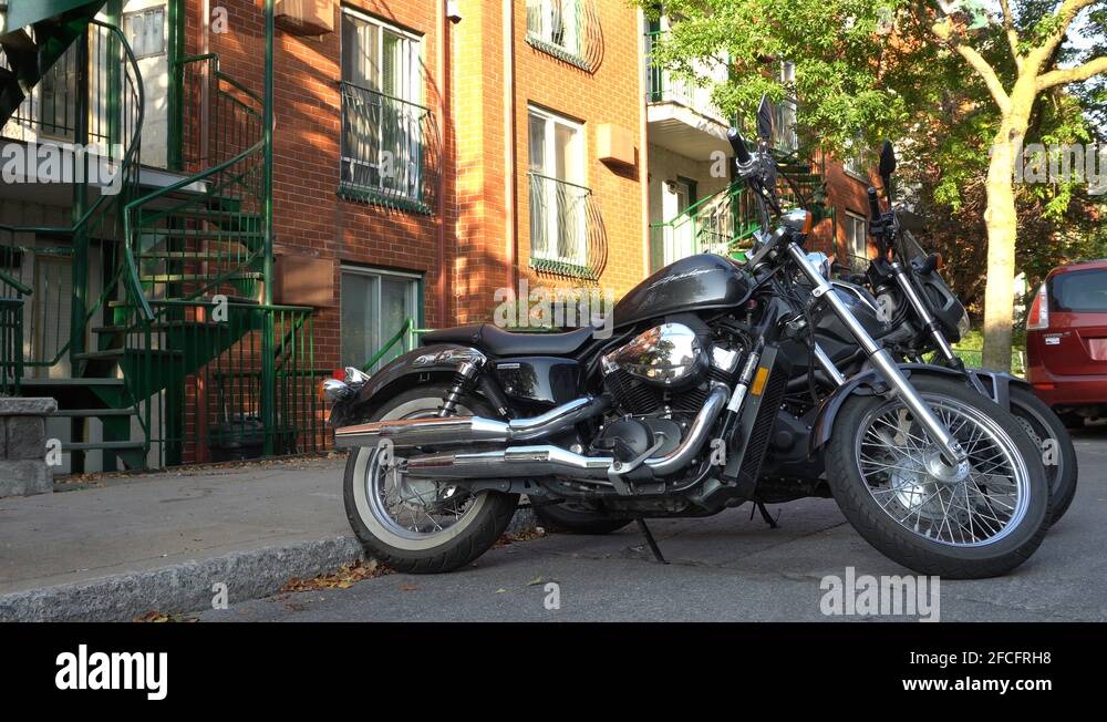 Two motorcycles in parallel parked in the street Stock Video Footage ...