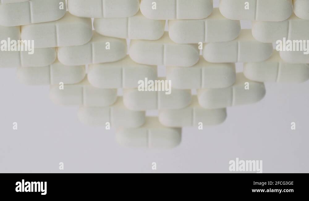 pyramid of white pills on a mirror surface Health Immunity Vitamins ...