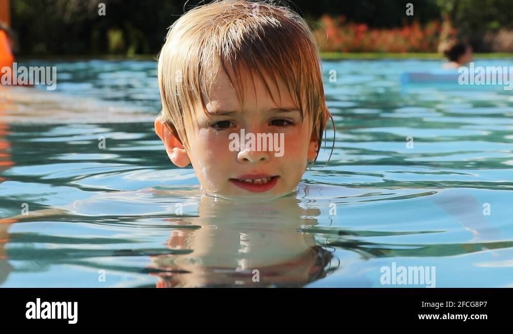 Young boy at the swimming pool waving to camera hello Stock Video ...