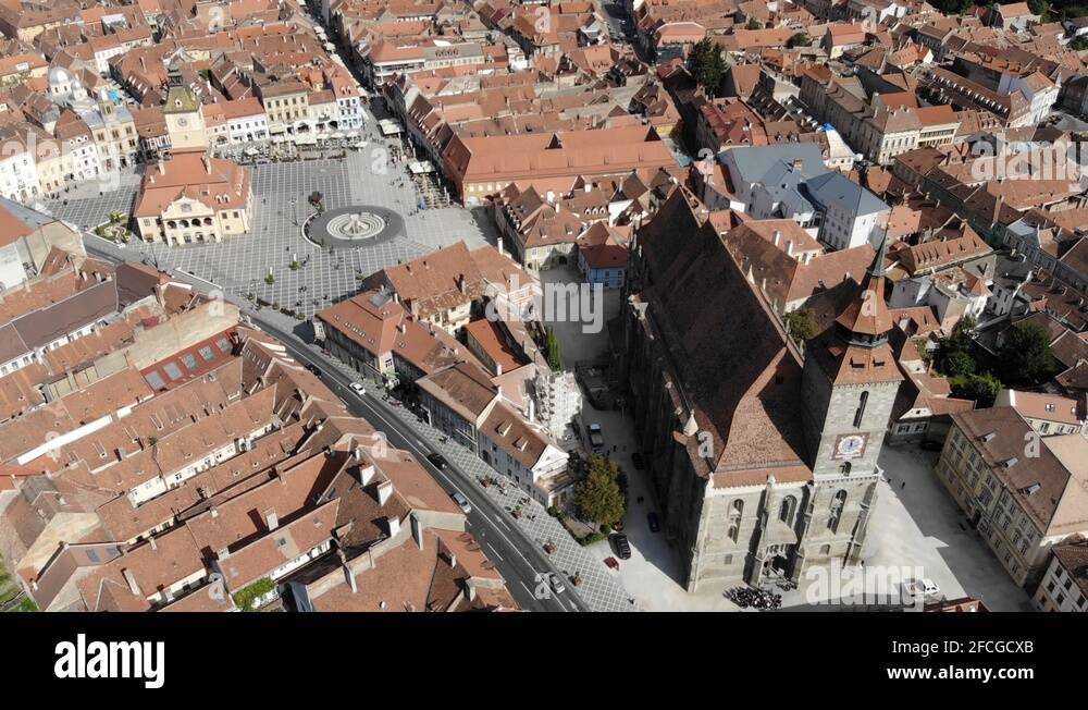 An aerial rotating shot around the Brasov's main square and the Black ...