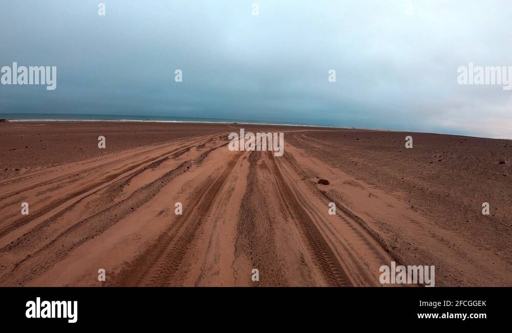 FPV of dune riding and 4x4 driving in sand dunes and on the beach. Shot ...
