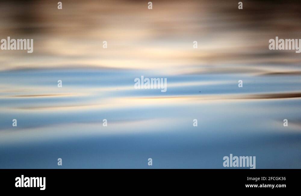 Liquid smooth lake water surface during sunset4 Stock Video Footage - Alamy