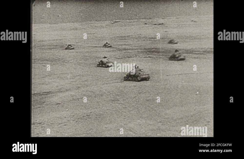 1940s: Tanks in desert. Low angle, Erwin Rommel looks through ...
