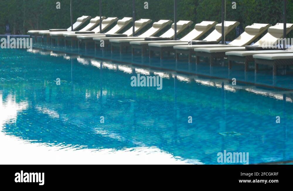 Row of empty deckchairs in front of empty pool of a luxury hotel Stock ...