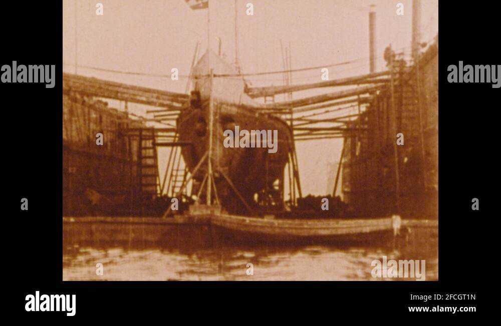 1900s: Sailors march. Ship comes out of dry dock. Men on ship. Bridge ...