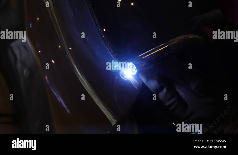 Gas metal arc or metal inert gas welding two pieces of metal together ...