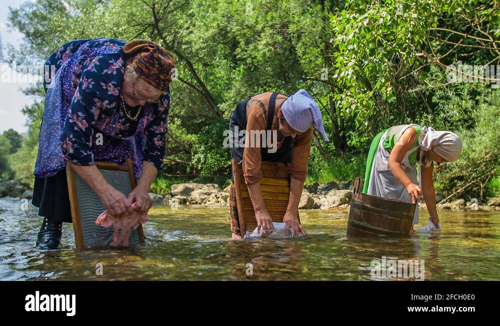 Older women are still washing clothes in the river Stock Video Footage ...