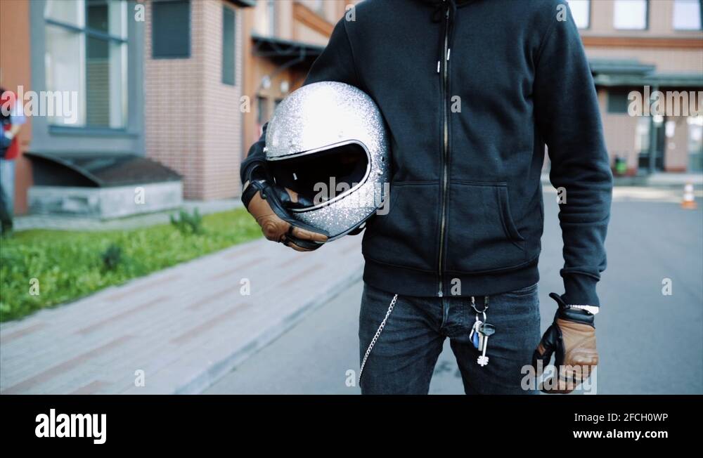 Biker goes to his cool and custom motorcycle in a big city Stock Video ...