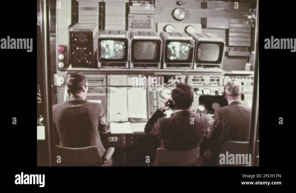1960s: Men sitting at control panel. President Kennedy talking to into ...