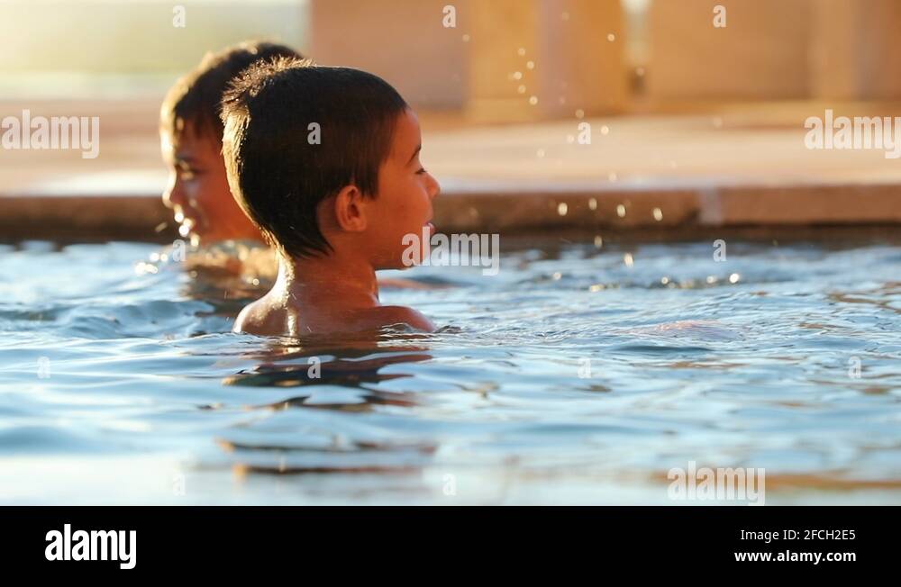 Two brothers together at the swimming pool Stock Video Footage - Alamy