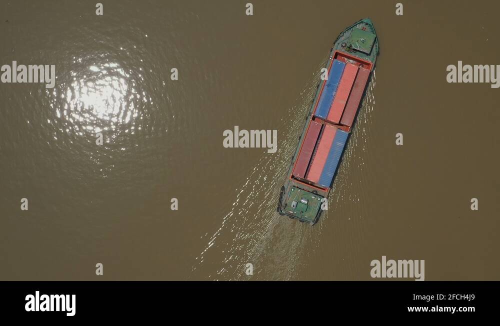 Top down view of freighter transporting shipping containers on a ...