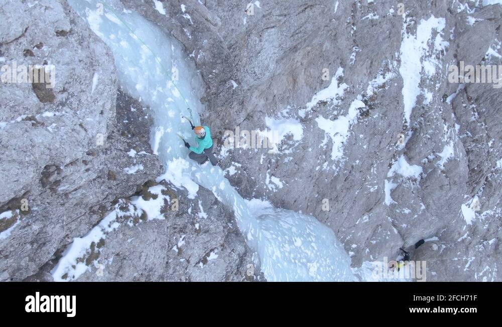 DRONE: Fearless woman climbs up the gorgeous crystal clear frozen ...