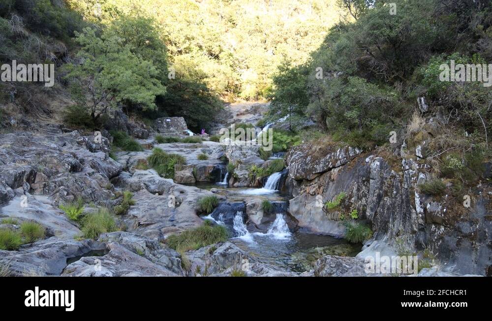 Amazing waterfalls pouring water trough the rocks in a beautiful ...