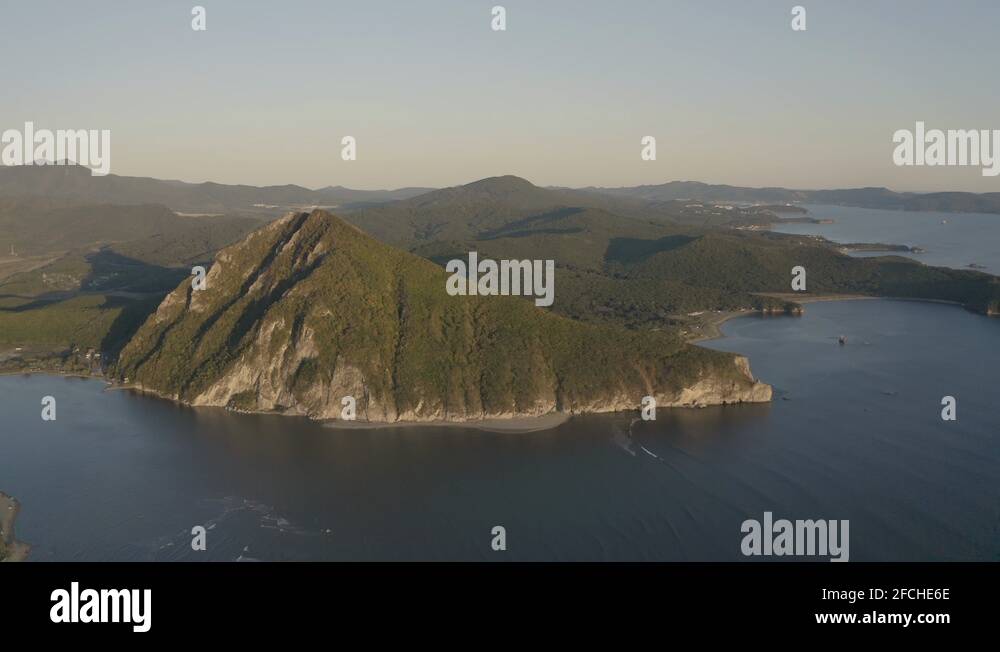 A landscape view of a pyramid-shaped mountain located at a river ...