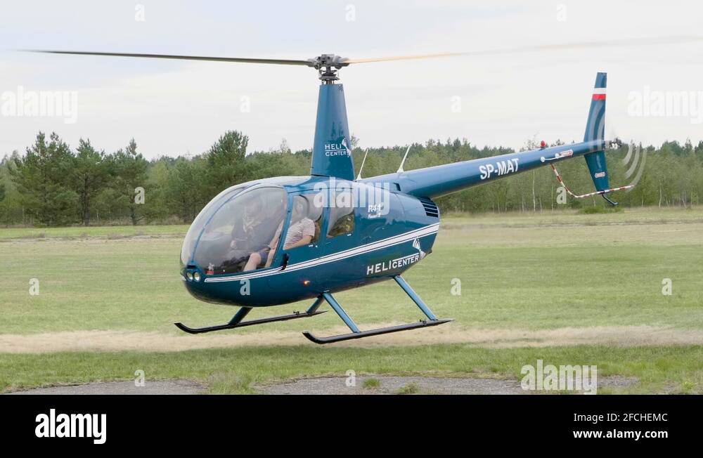 Private military Robinson R44 Raven II helicopter taking off in slow ...