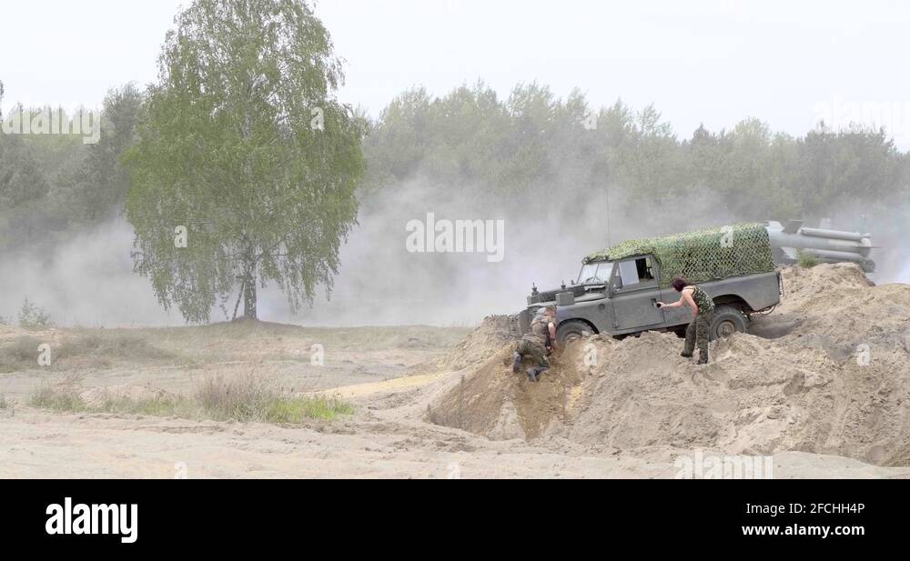 Male digging military truck from dirt mound hill at Borne Sulinowo ...