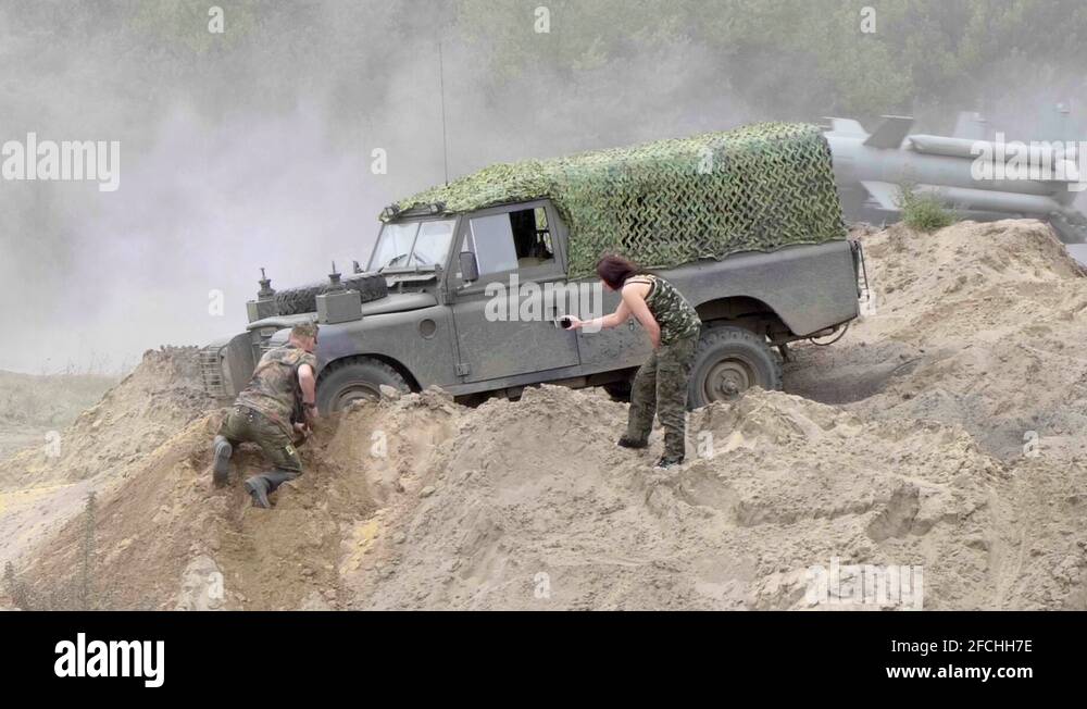 Male digging military truck from dirt mound hill at Borne Sulinowo ...