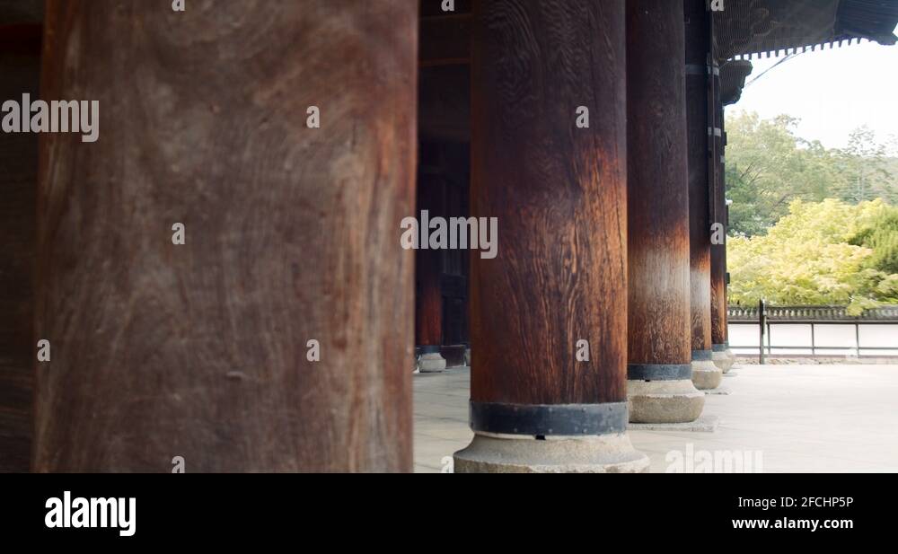 Slide shot of huge wooden pillars in a temple in Kyoto, Japan 4K slow ...