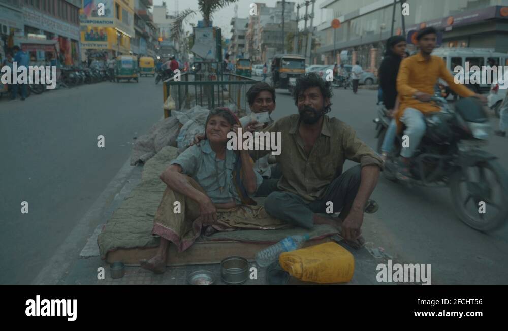 Smiling Family Of Homeless People Living On The Street In The Middle Of ...