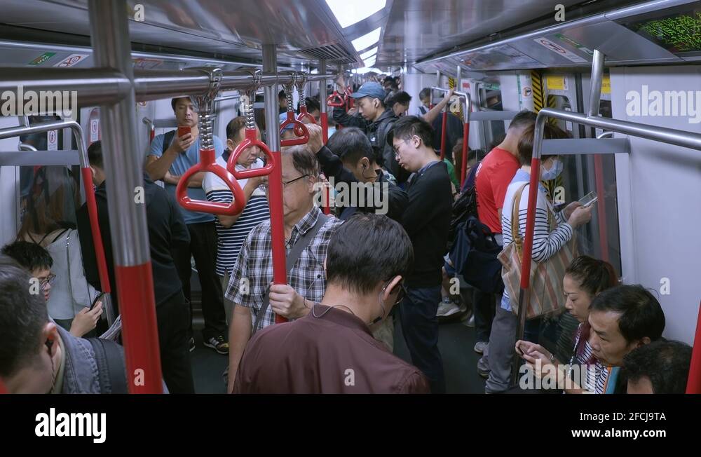Commuters on a crowded Mass Transit Railway or MRT train on the Hong ...