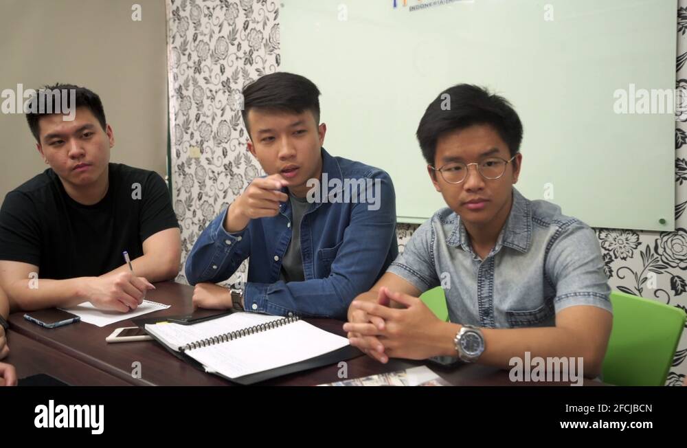 4K footage of Asian male raising hand and asking questions during a ...