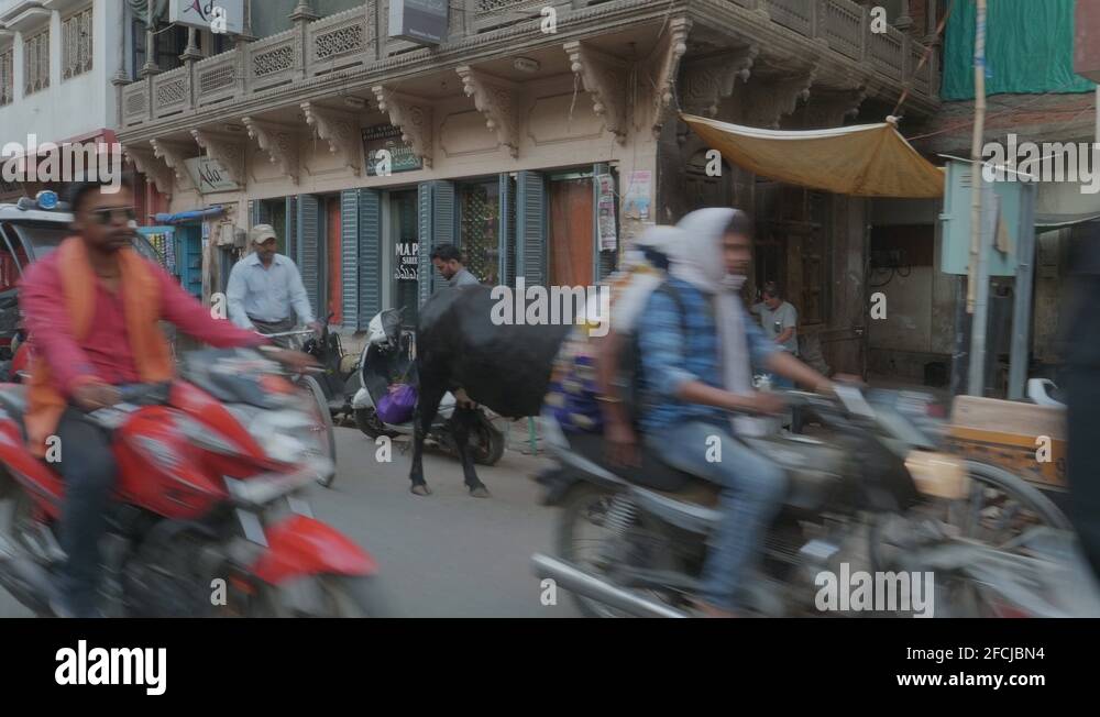Walking Down A Busy Street In India Past Market Stalls And People Stock ...