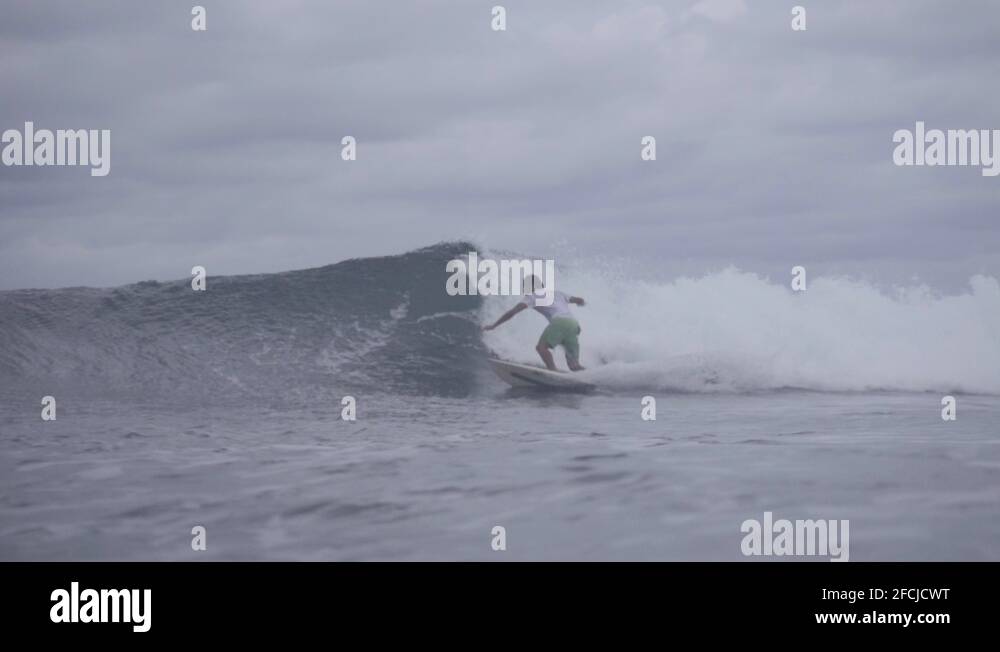 Asian Filipino Surfers Enjoying Small Waves In Gloomy Weather Stock ...