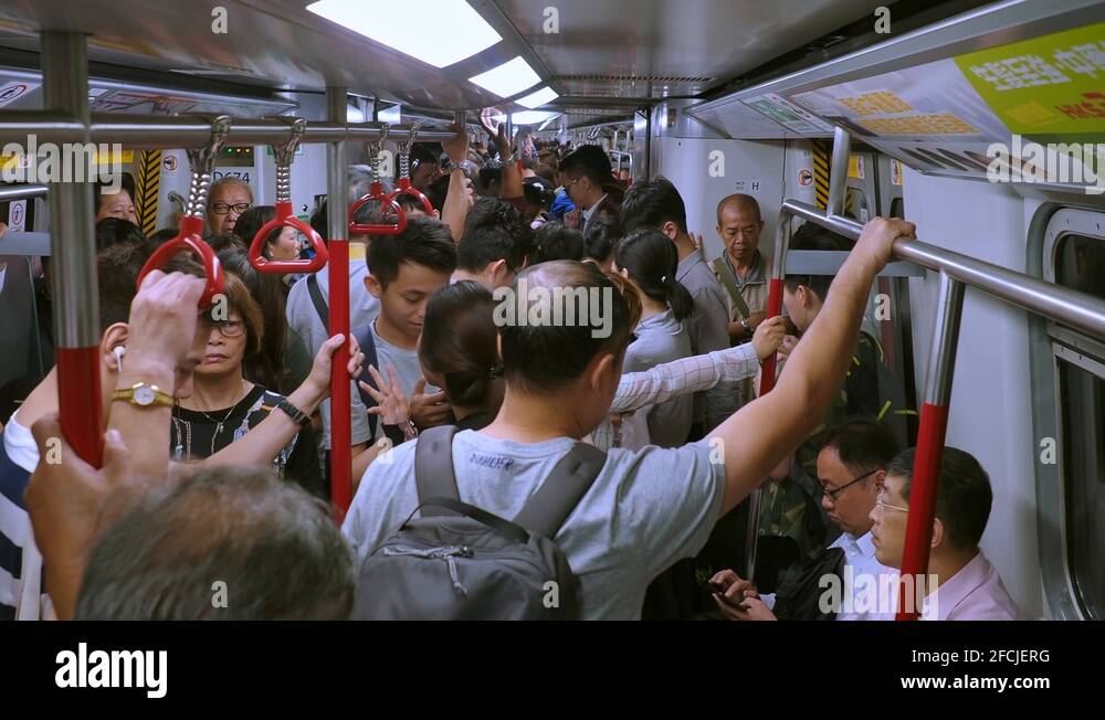 Commuters on a crowded Mass Transit Railway or MRT train on the Hong ...