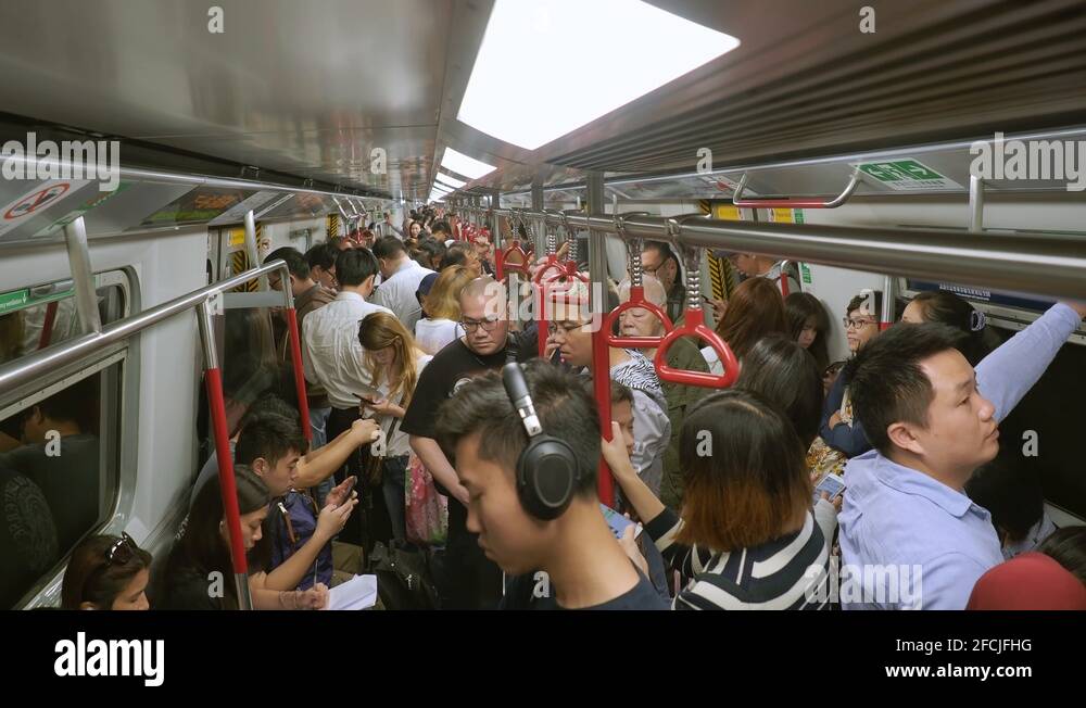 Commuters on a crowded Mass Transit Railway or MRT train on the Hong ...