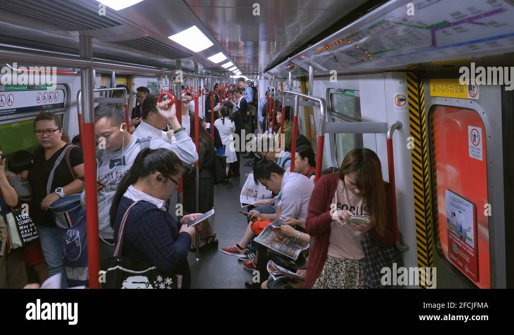 Commuters on a crowded Mass Transit Railway or MRT train on the Hong ...