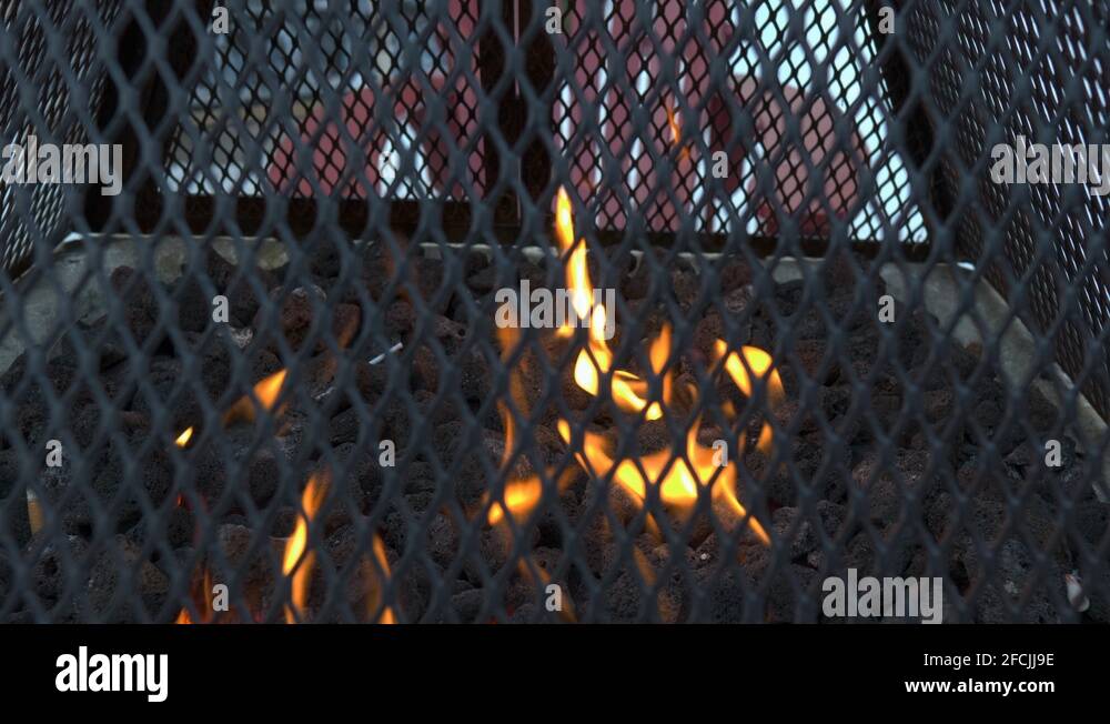 Fire flames enclosed in safety grate Stock Video Footage - Alamy