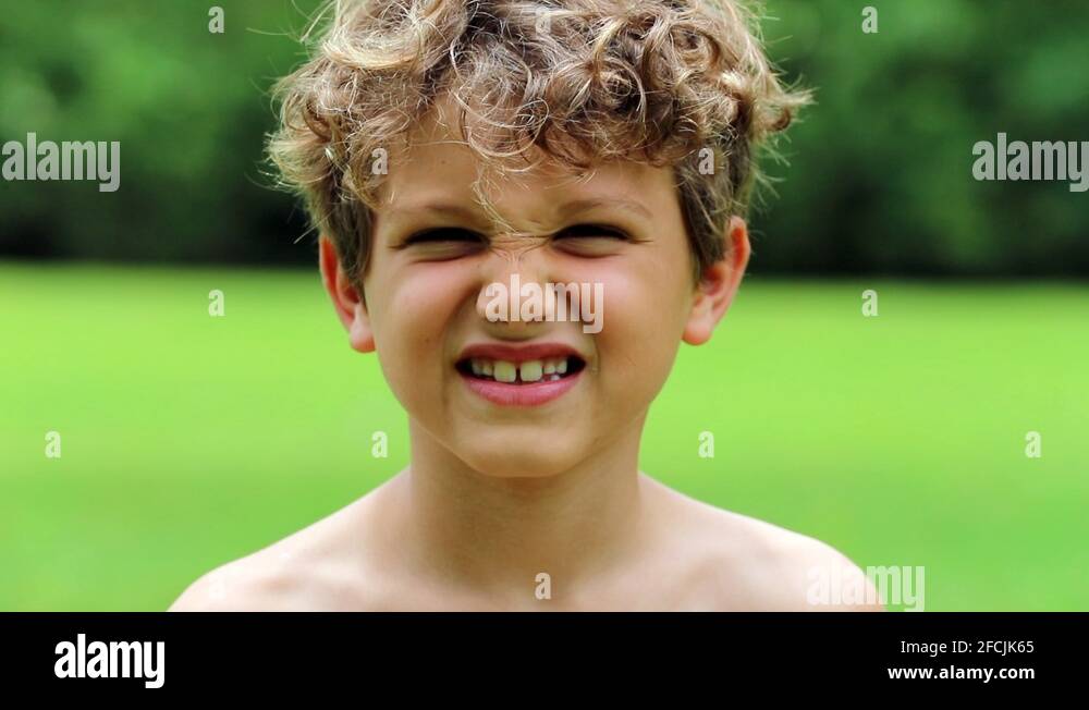 Portrait of young boy yelling screaming or roaring from top of his ...