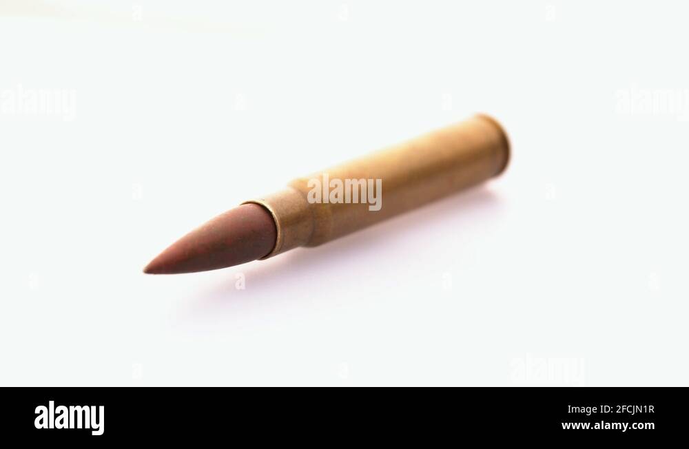 Sniper rifle bullet with shell casing on a white background, rotating ...