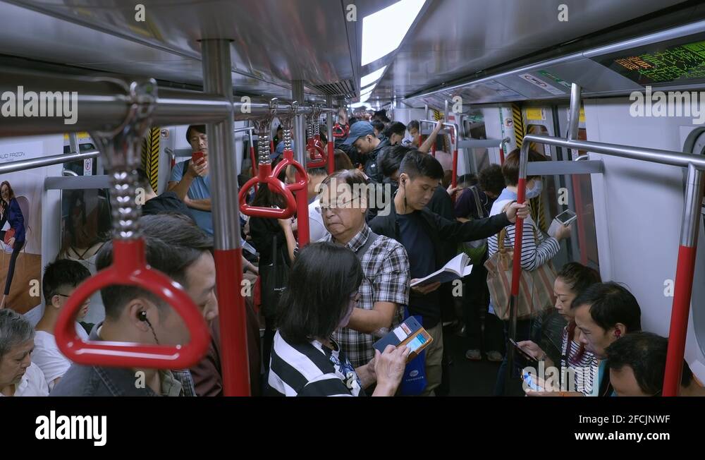 Commuters on a crowded Mass Transit Railway or MRT train on the Hong ...